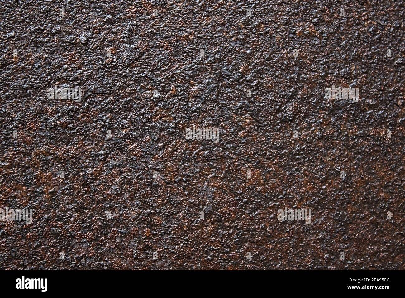 It's an old, rusty, dark-colored metal surface. Abstract background ...
