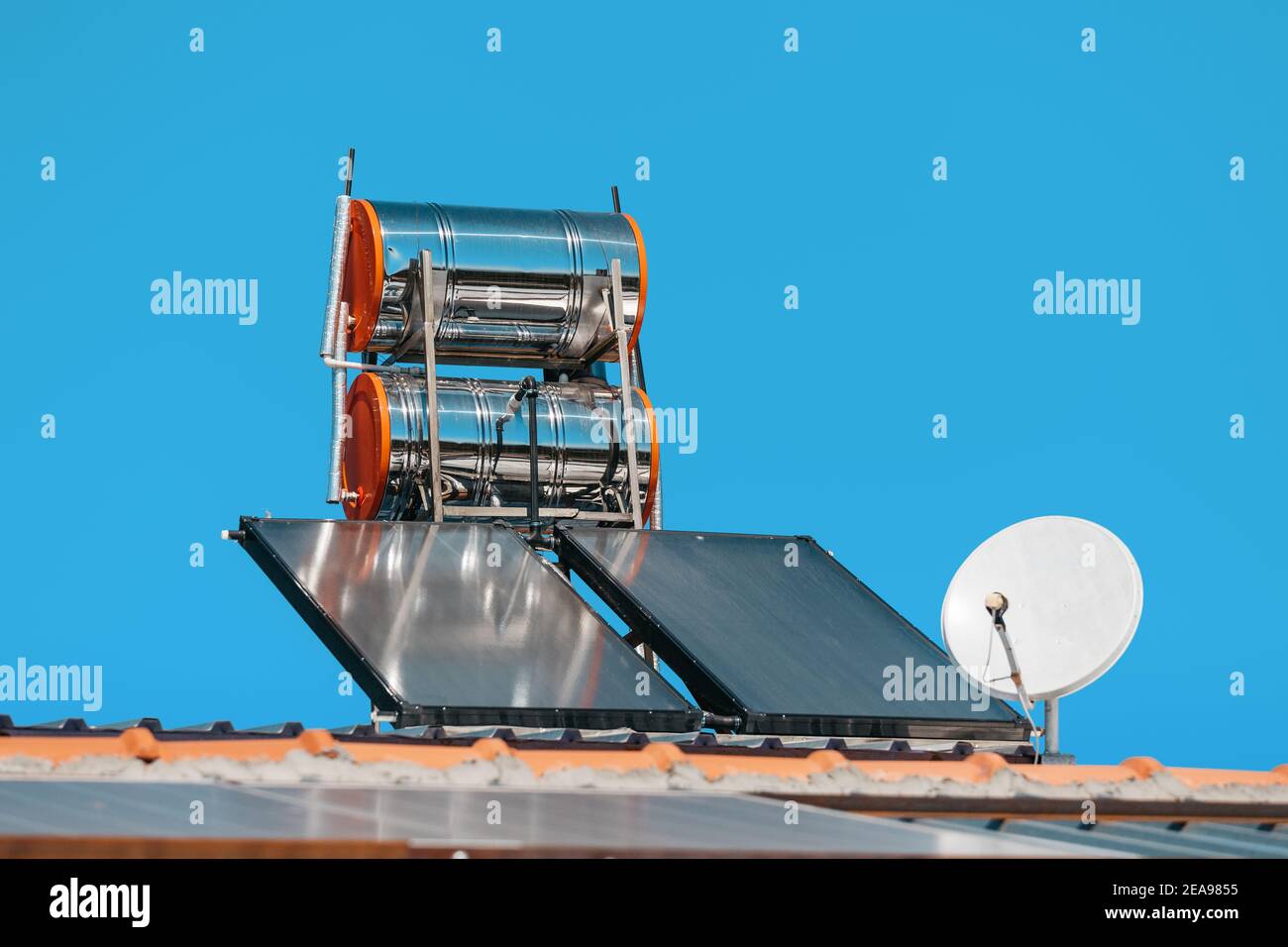 Solar panels on the roof of the cottage with water barrels and TV or ...