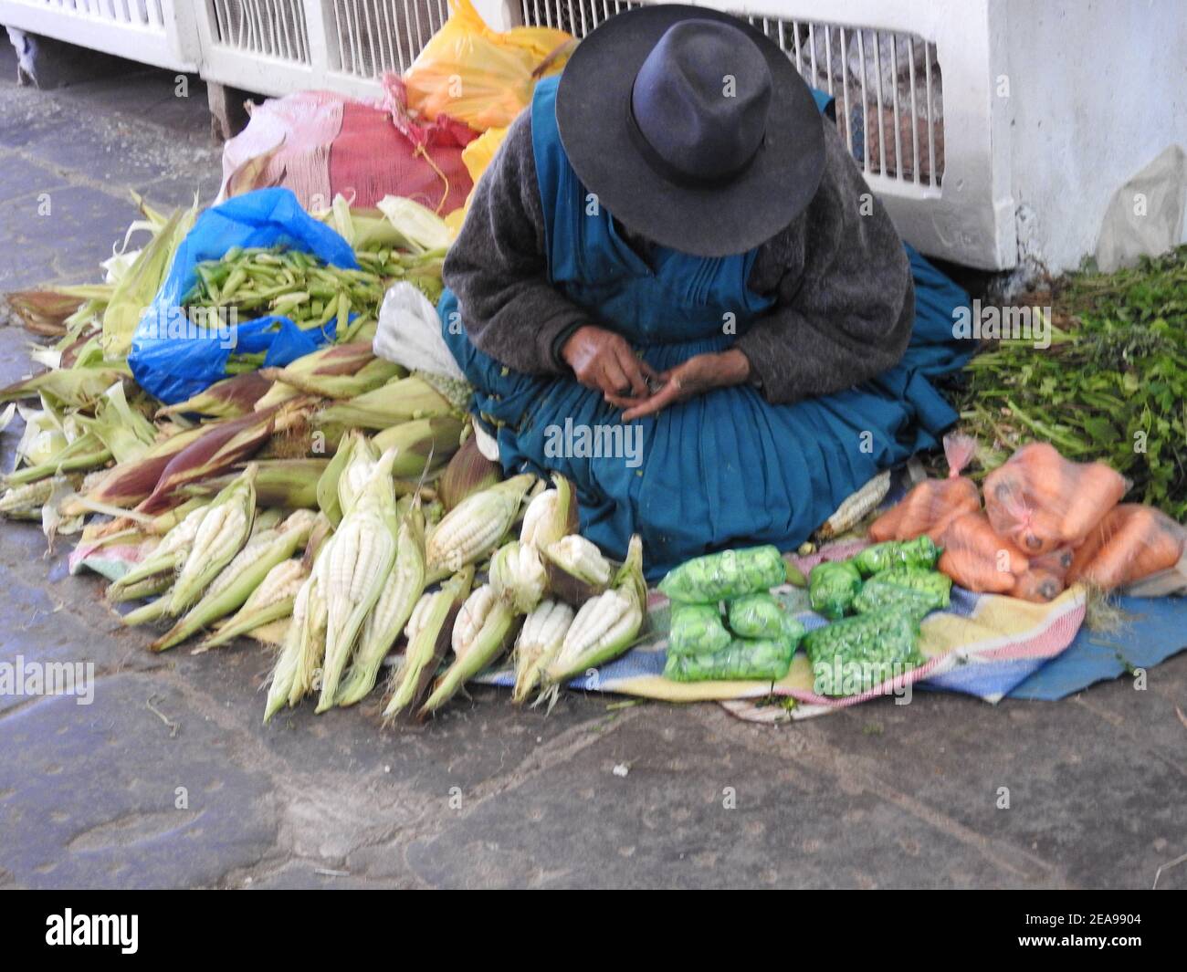 Peruvian female selling vegetables at a market Stock Photo - Alamy