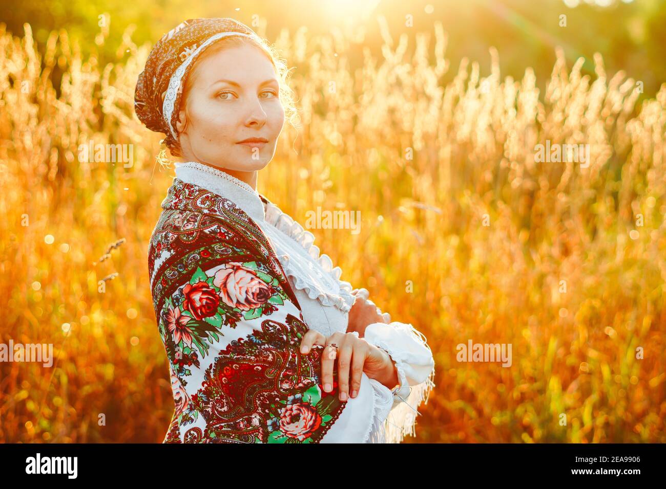 Young beautiful slovak woman in traditional costume on summer daisy ...