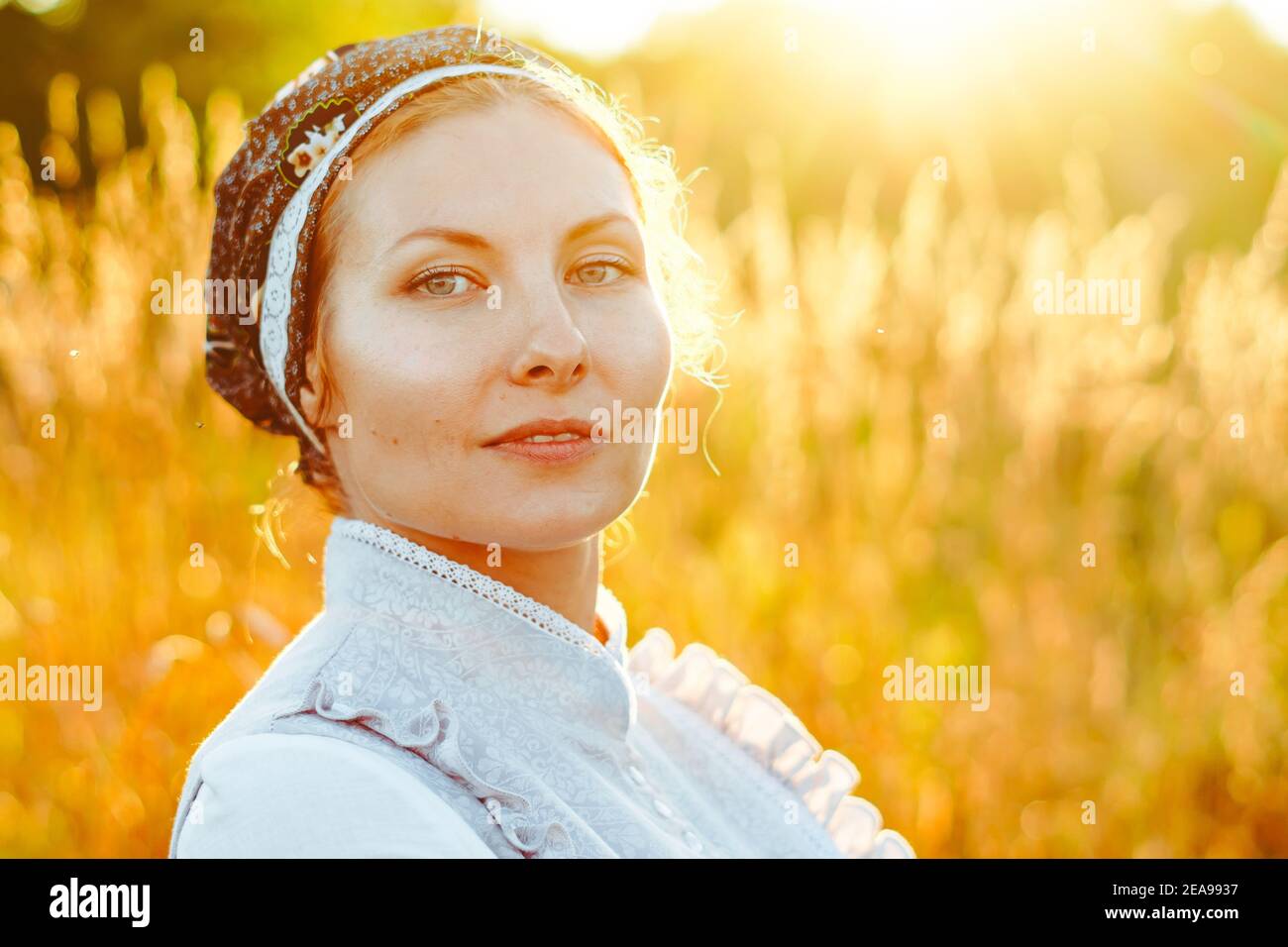 Young beautiful slovak woman in traditional costume on summer daisy ...
