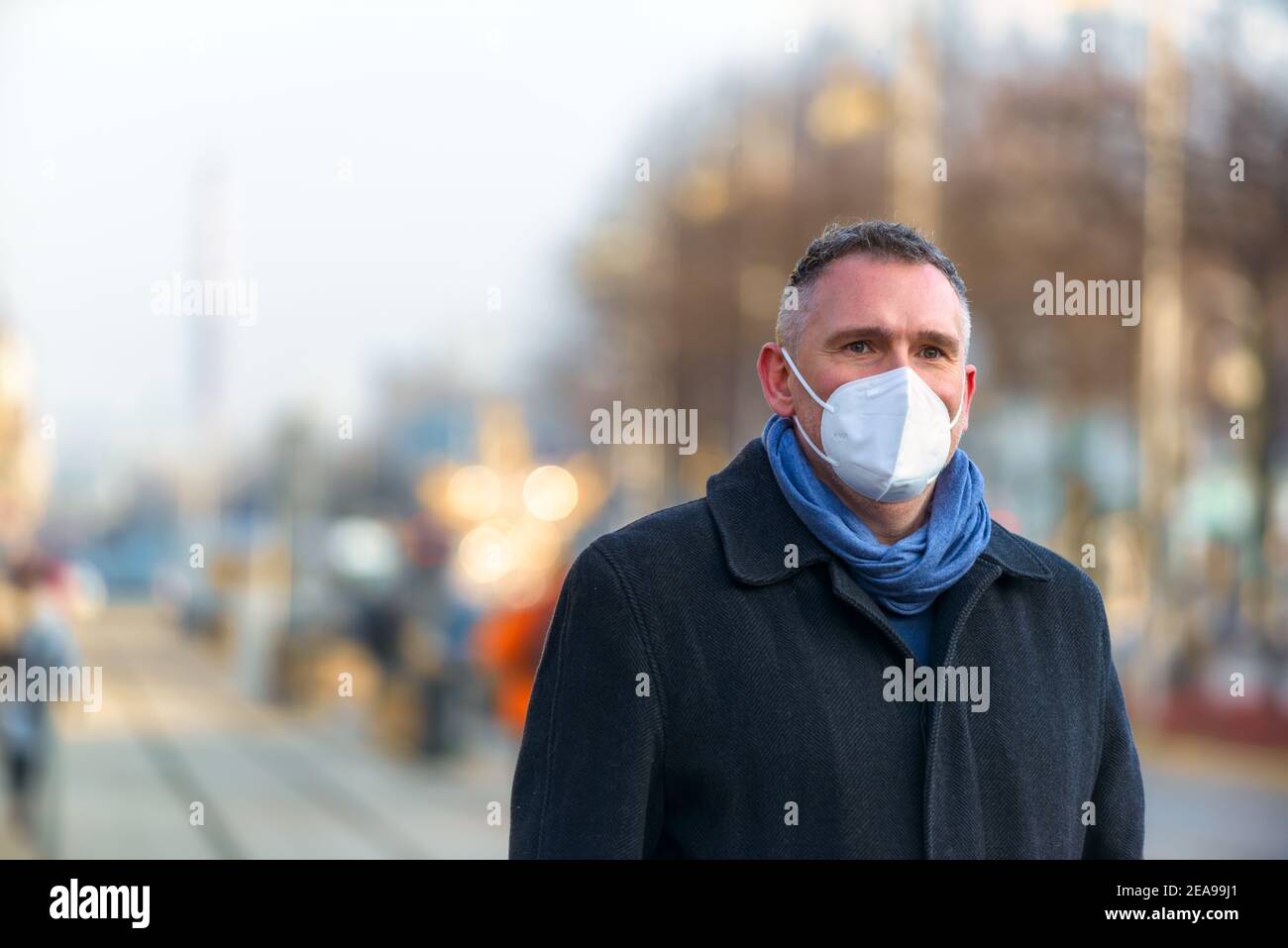 Man wearing protection mask walking on a city street Stock Photo - Alamy