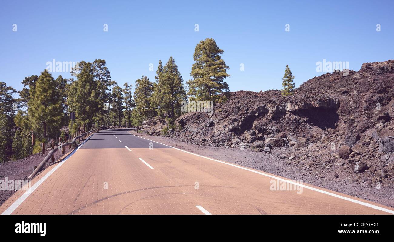 Scenic road through volcanic terrain, retro style toned picture ...