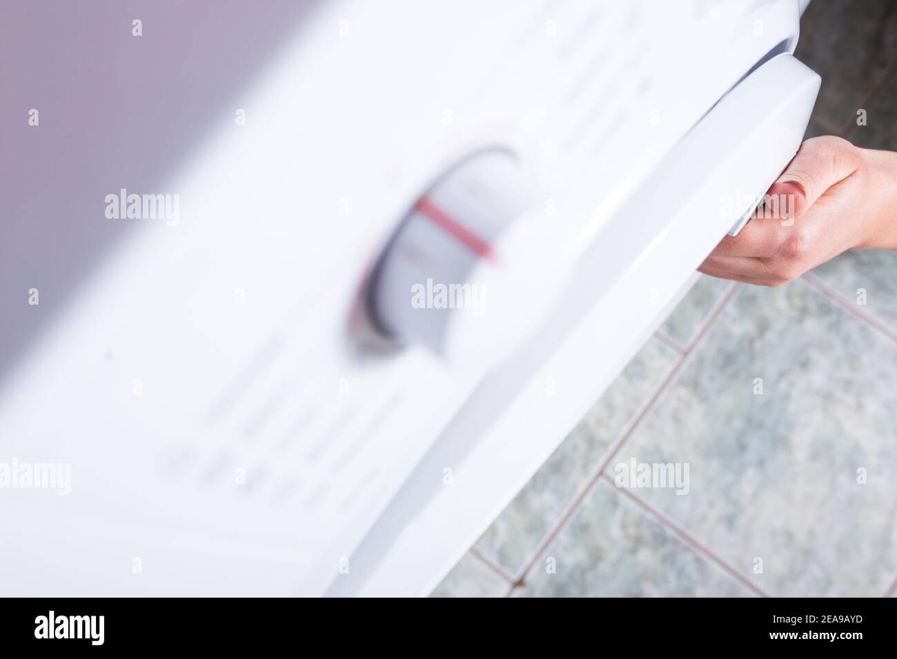 Hand opening washing machine door close up, at home Stock Photo - Alamy