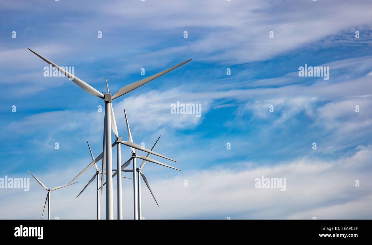 Wind turbines on blue cloudy sky background, Wind farm, aerial drone ...