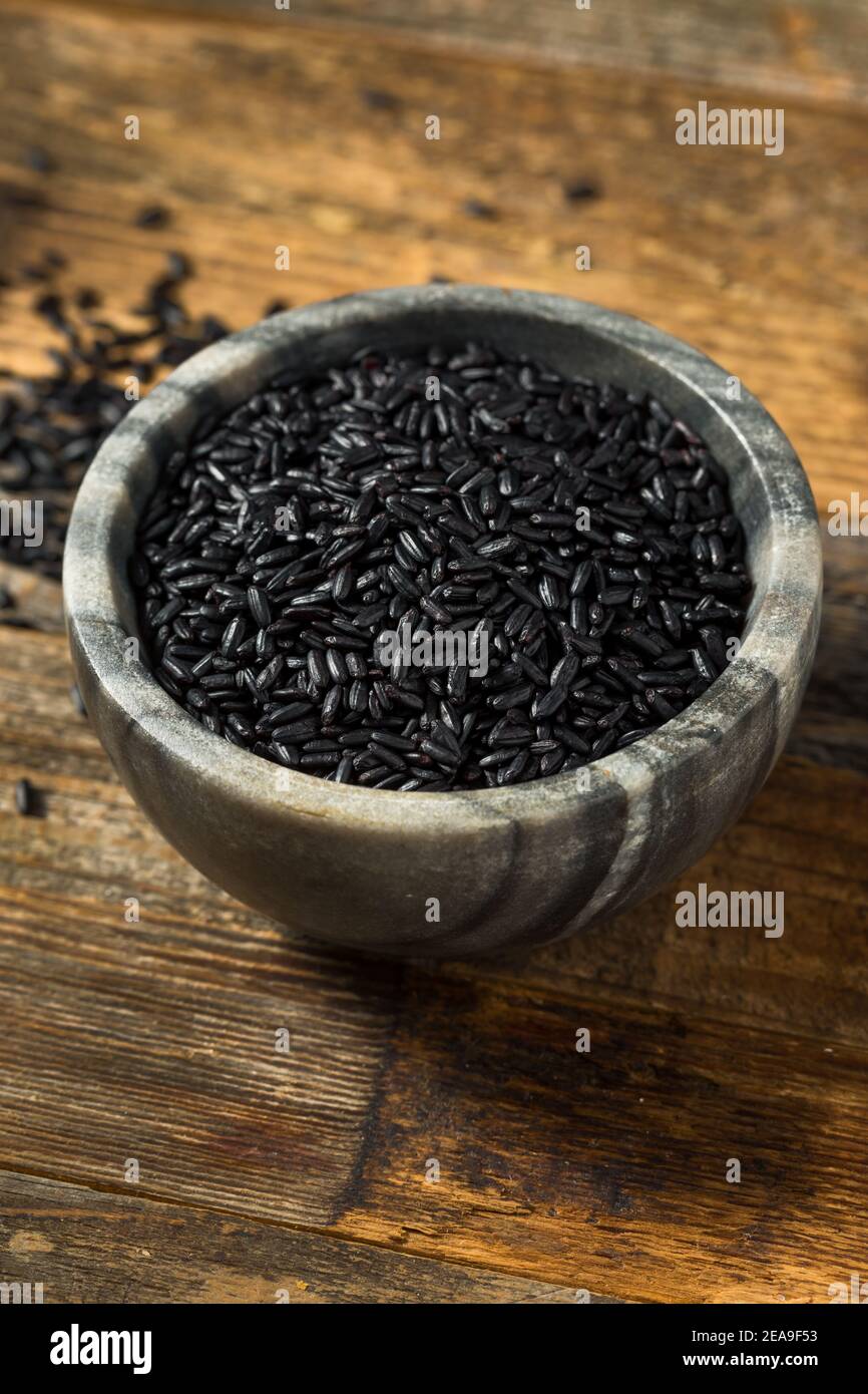 Dry Organic Asian Black Rice in a Bowl Stock Photo - Alamy