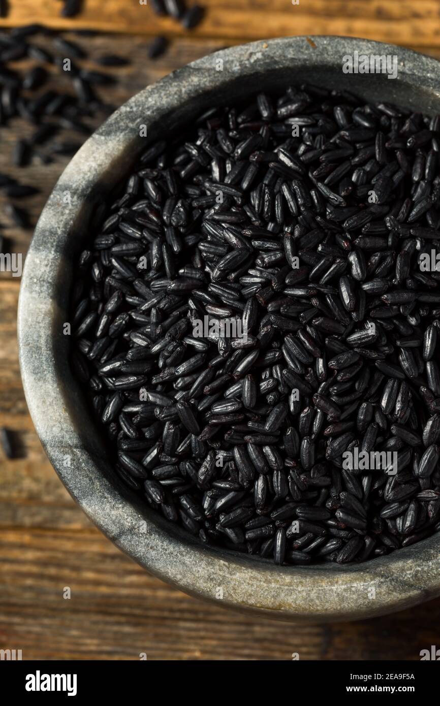 Dry Organic Asian Black Rice in a Bowl Stock Photo - Alamy