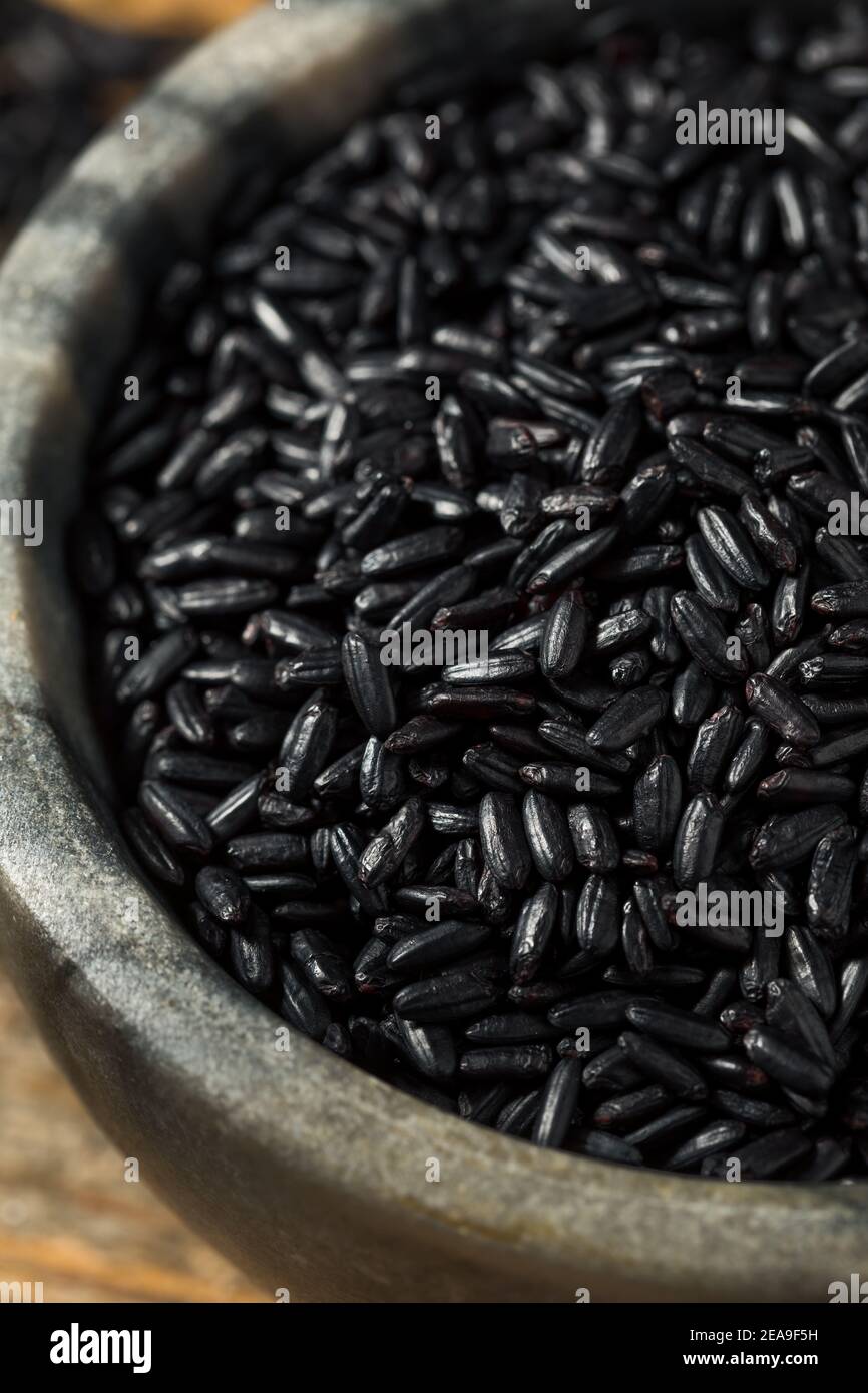 Dry Organic Asian Black Rice in a Bowl Stock Photo - Alamy