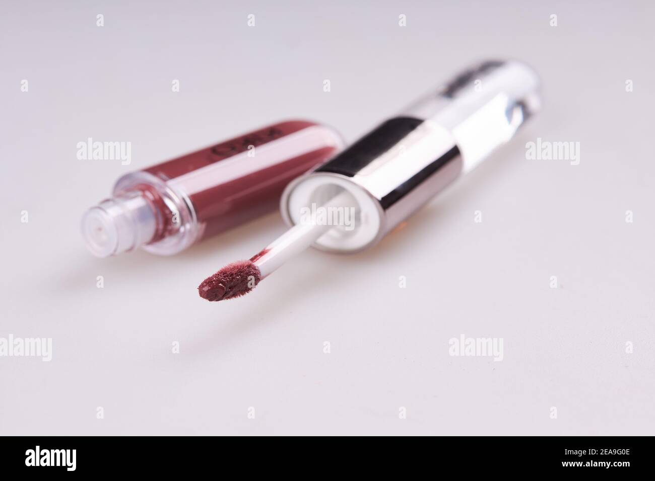 Tube of liquid lipstick gloss with applicator isolated on white ...