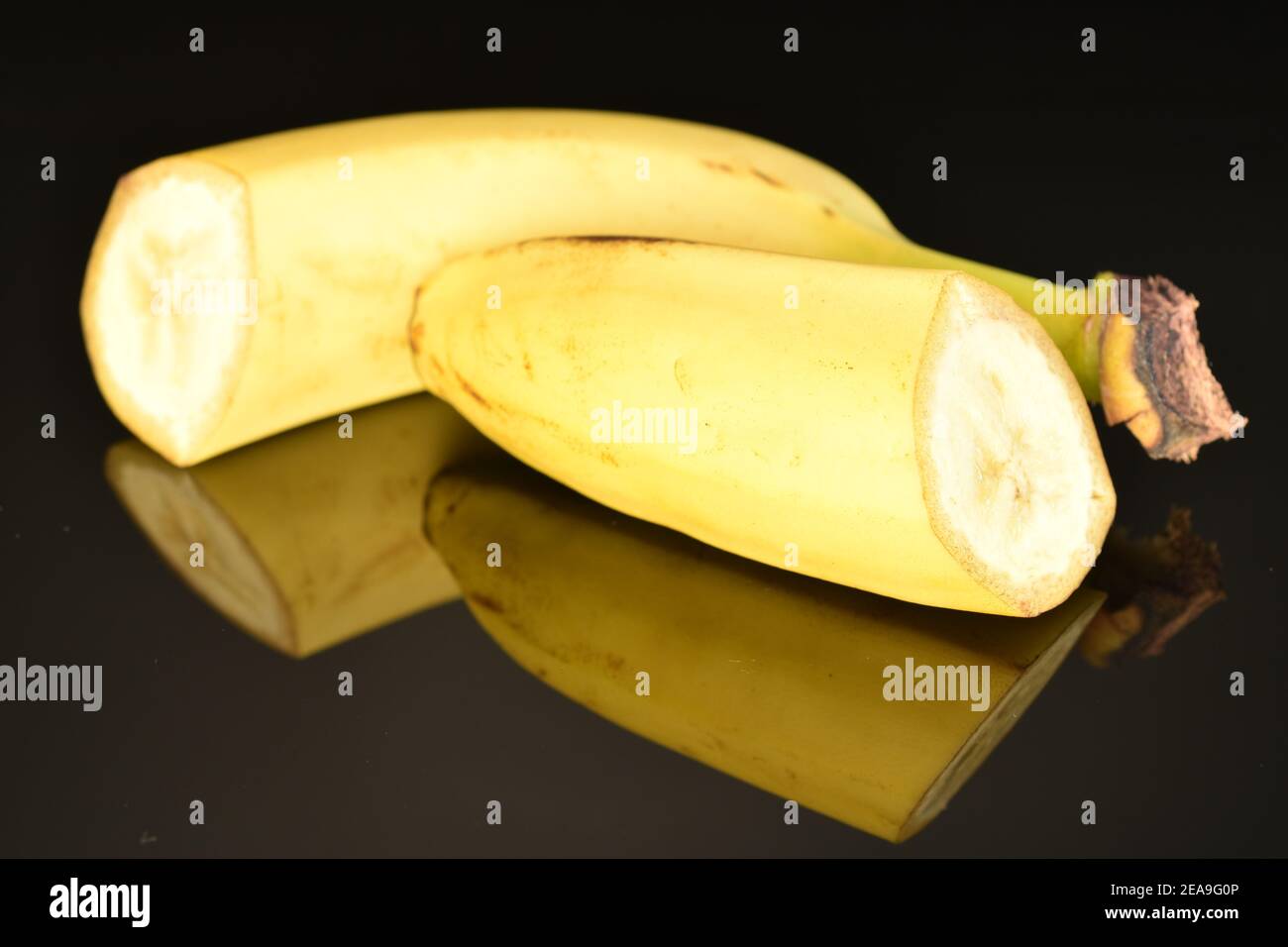 One, cut in half, bright yellow ripe, sweet, nutritious, organic banana ...