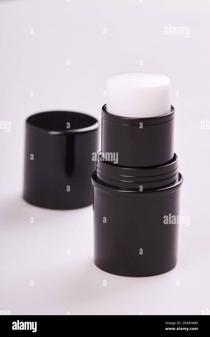 Face primer in a black tube isolated on white. Perfecting face base in ...