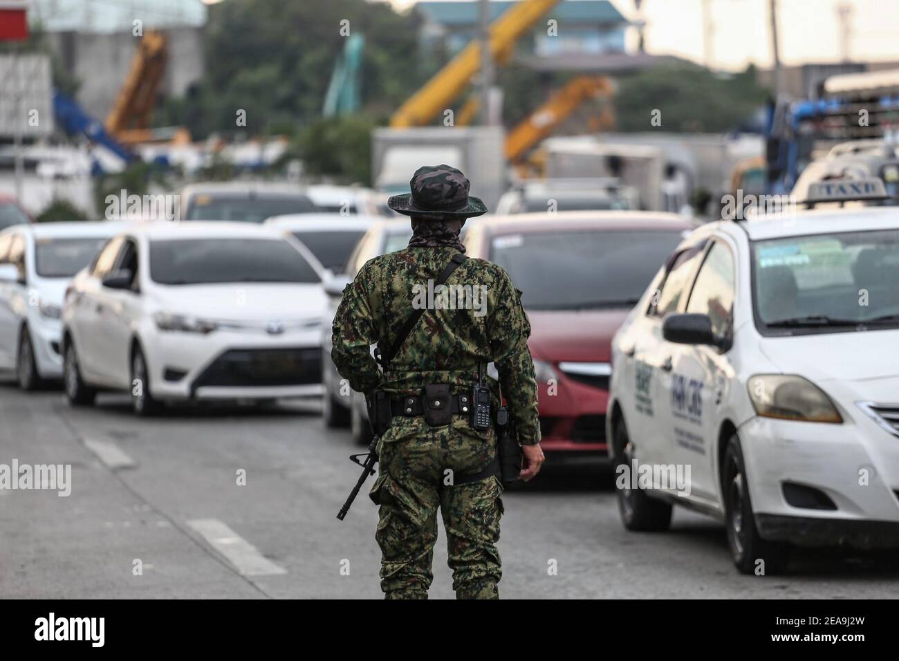 Filipino soldiers stand guard at a checkpoint after being deployed as ...