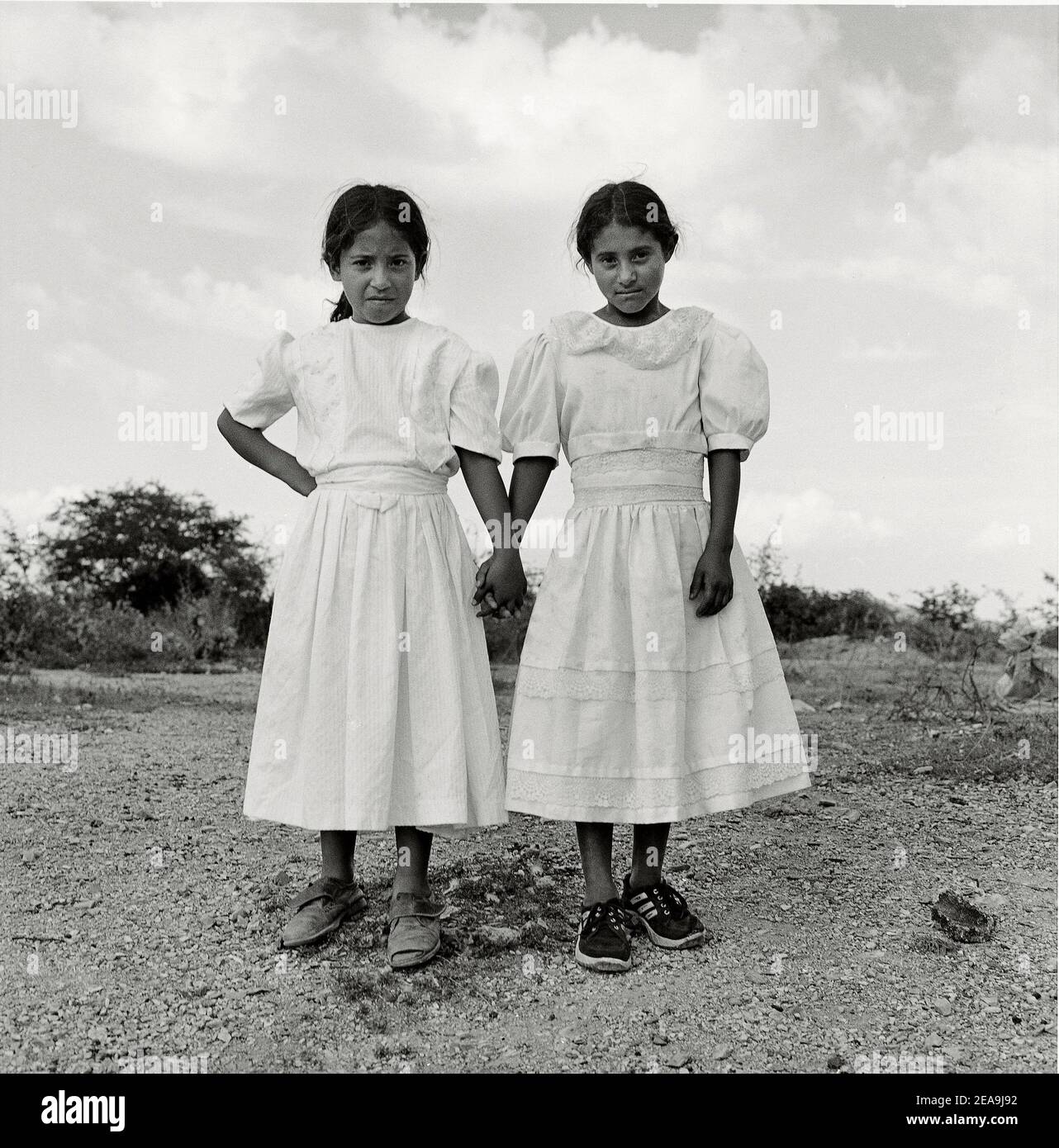 Portrait of happy twin sisters wearing white dress Lara, Lara state ...