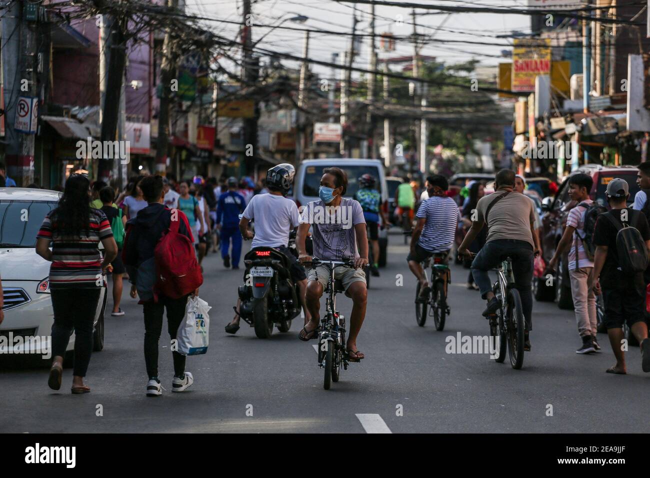 People walk and use their bicycles as mass transportation has been ...