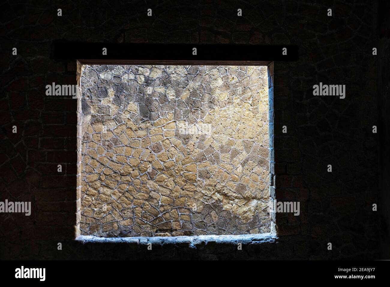 Ancient wall of limestone framed with a window as background in the ...