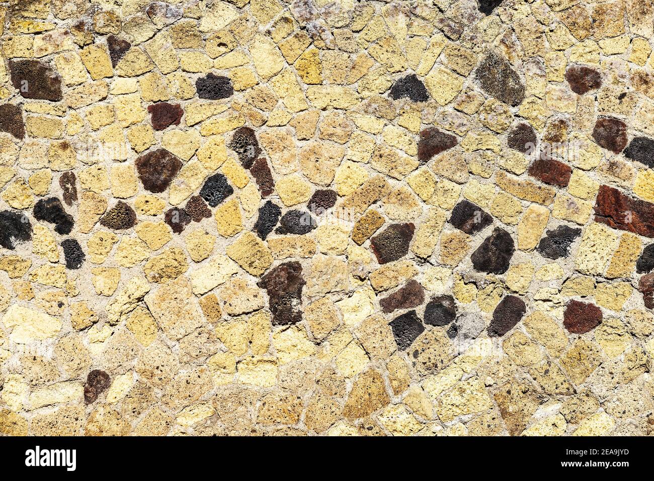 Ancient wall with washed out limestone and remaining concrete as ...