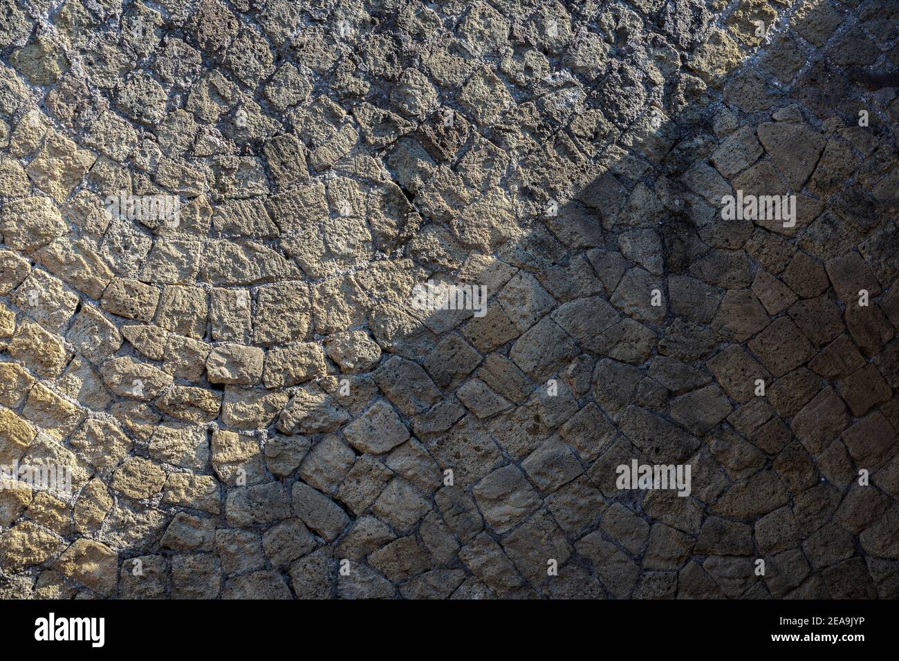 Ancient wall with washed out limestone and remaining concrete as ...