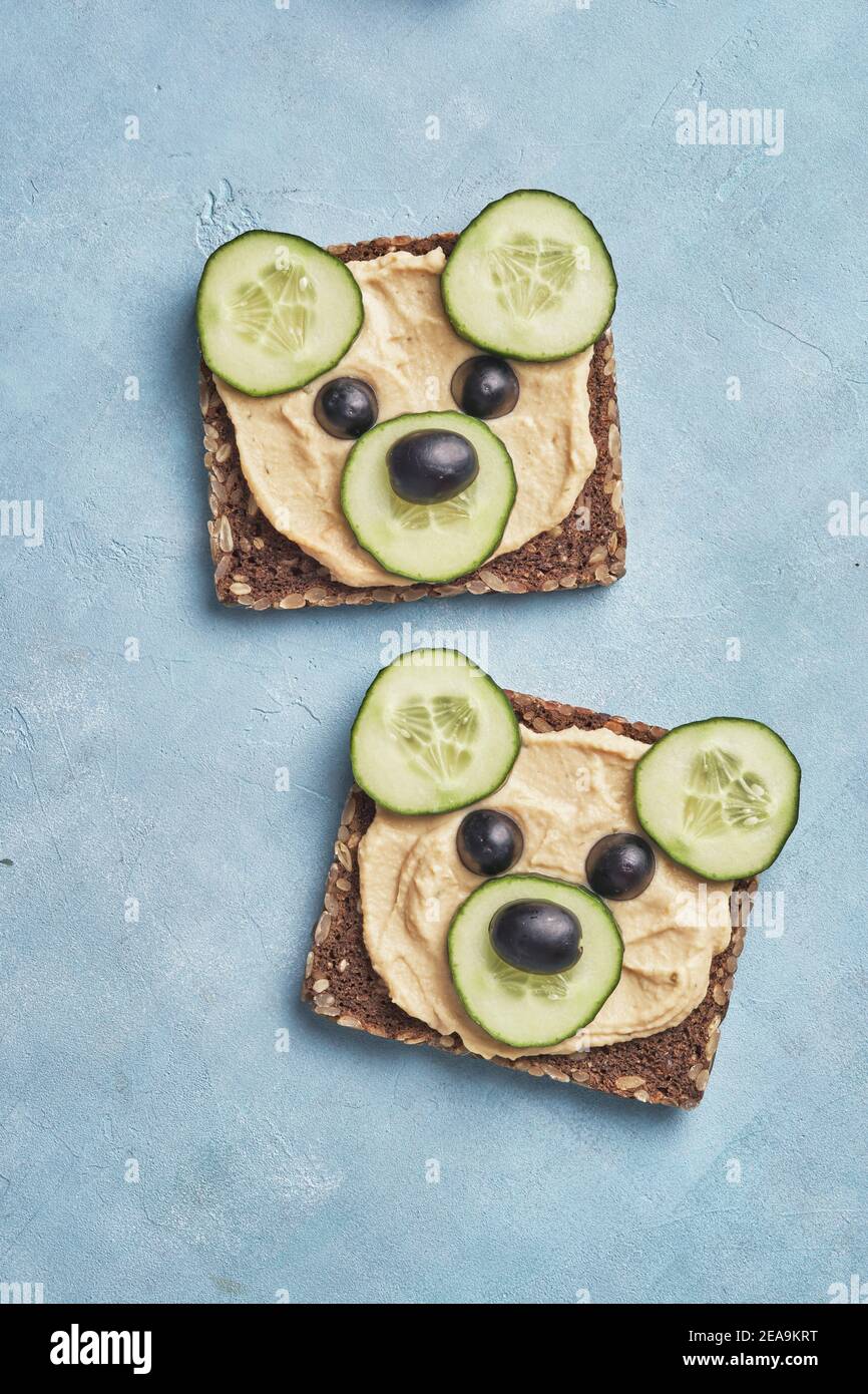 Funny bear toast with cucumber and hummus toasts Stock Photo - Alamy