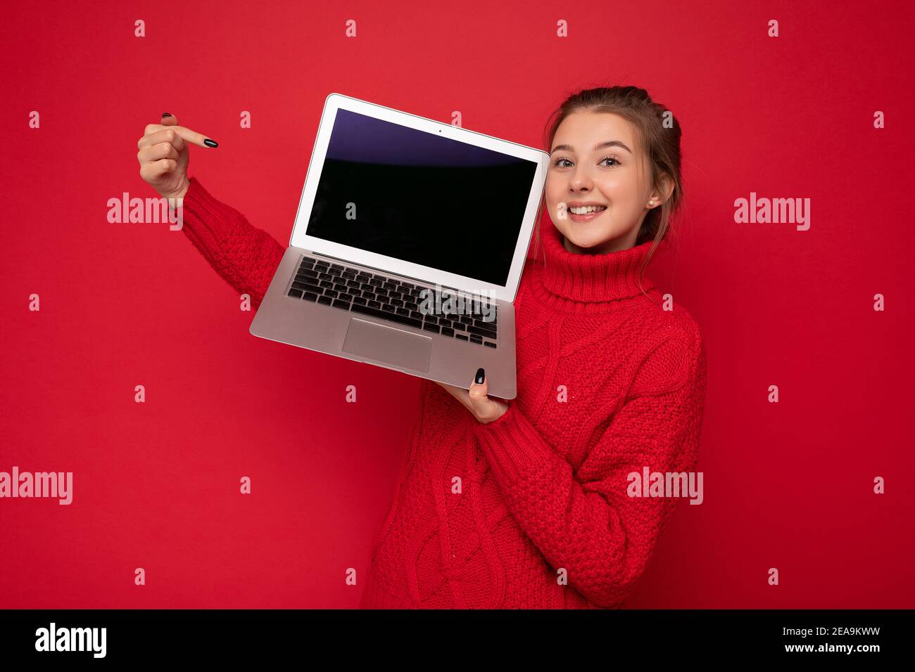 Photo of Beautiful satisfied happy young woman holding computer laptop ...