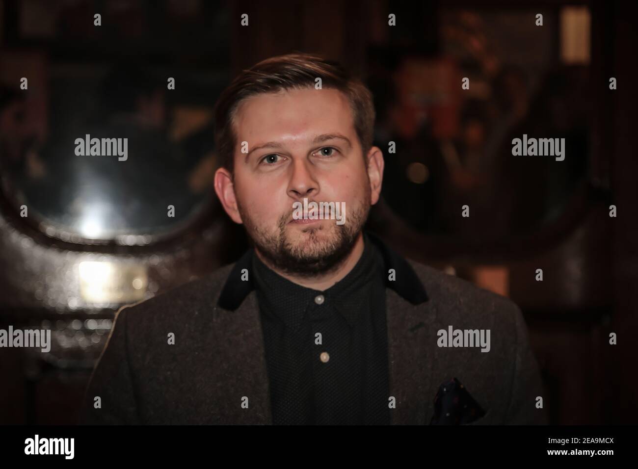 Greg McHugh posing for photos on the red carpet before attending the ...