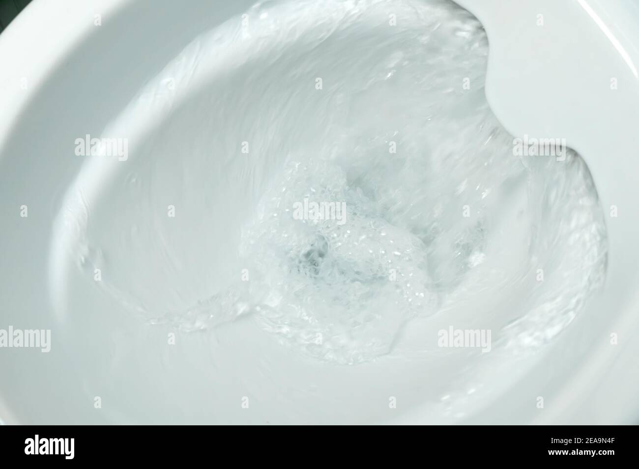 Close-up of flushing water in a white rimless toilet bowl Stock Photo ...