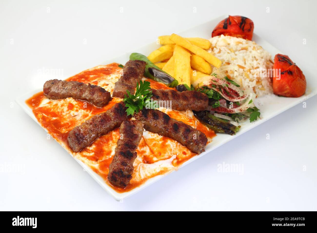 Plate of traditional grilled meatballs on white background Stock Photo ...