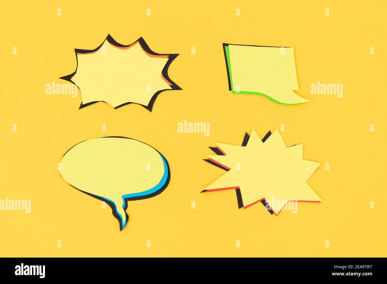 Paper speech bubbles on yellow background. Comic Stock Photo - Alamy