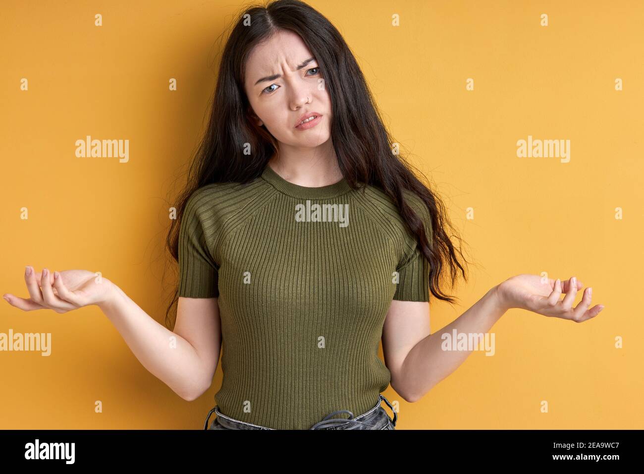 outraged woman throwing up hand and expressing misunderstanding ...