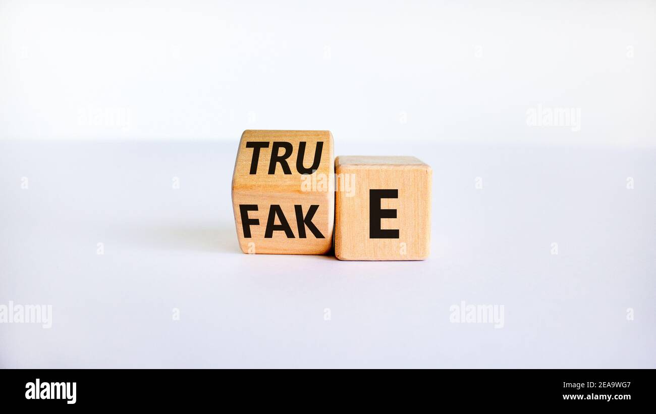Fake or true symbol. Turned a wooden cube and changed the word 'fake ...
