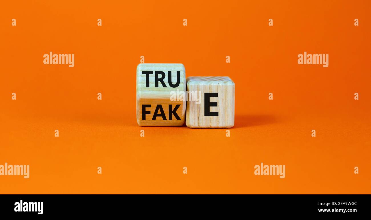 Fake or true symbol. Turned a wooden cube and changed the word 'fake ...