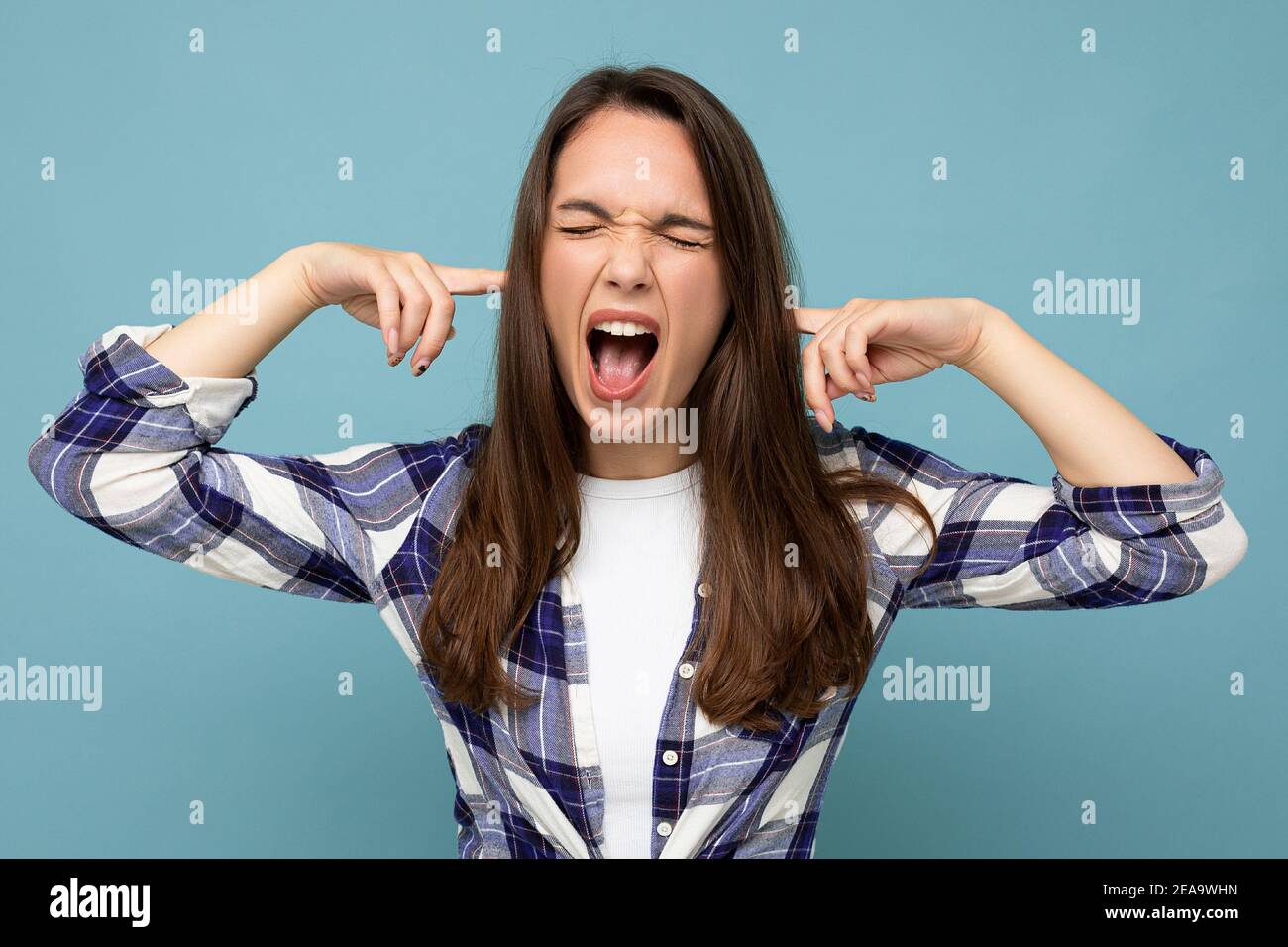 Woman shouting fingers in ears hi-res stock photography and images - Alamy