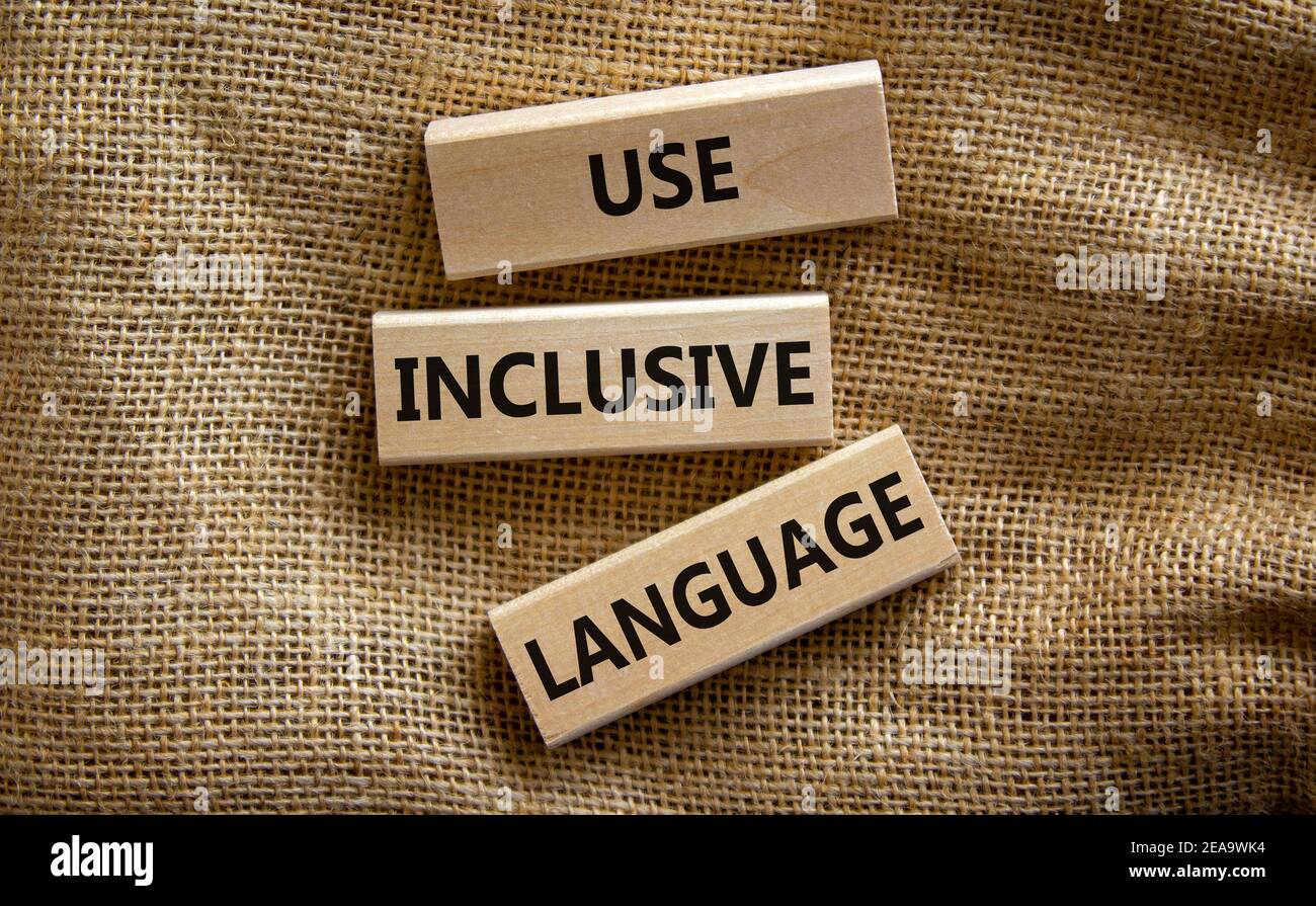 Use inclusive language symbol. Wooden blocks with words 'Use inclusive language'. Beautiful ...