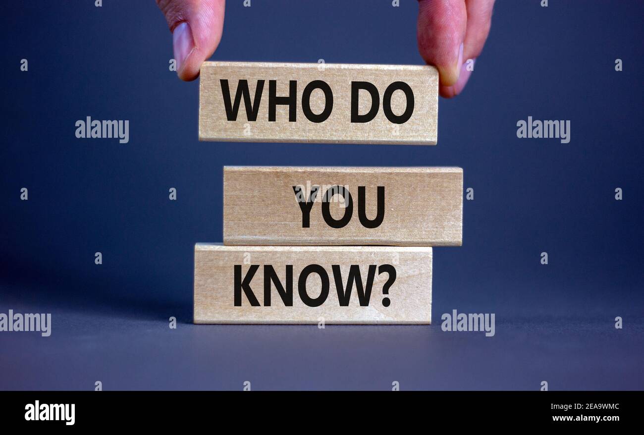 Who do you know symbol. Businessman hand. Wooden blocks with words 'who ...