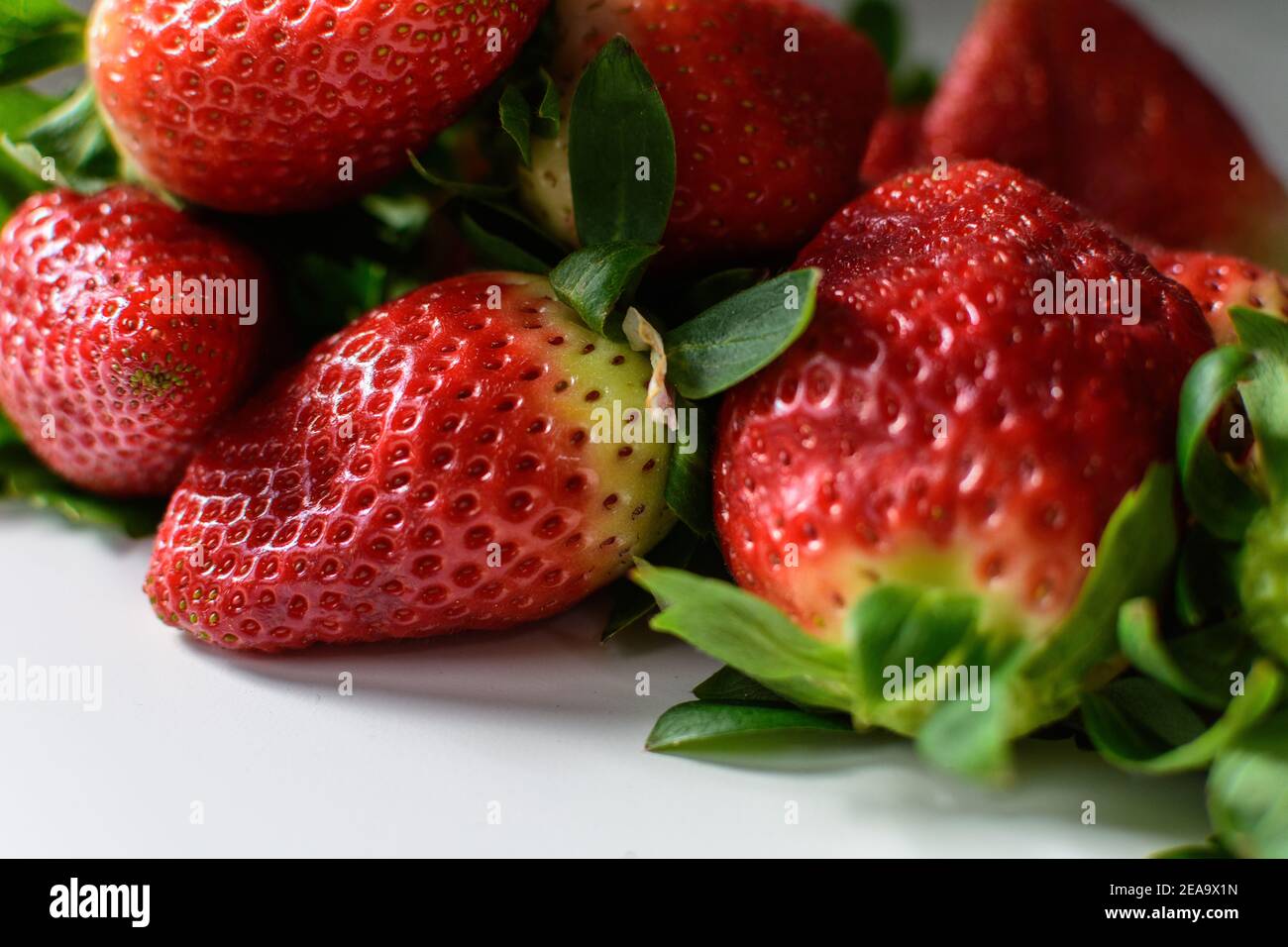 A bunch of bright red strawberries on a white background Stock Photo ...
