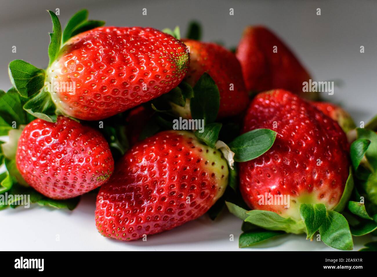 A bunch of bright red strawberries on a white background Stock Photo ...
