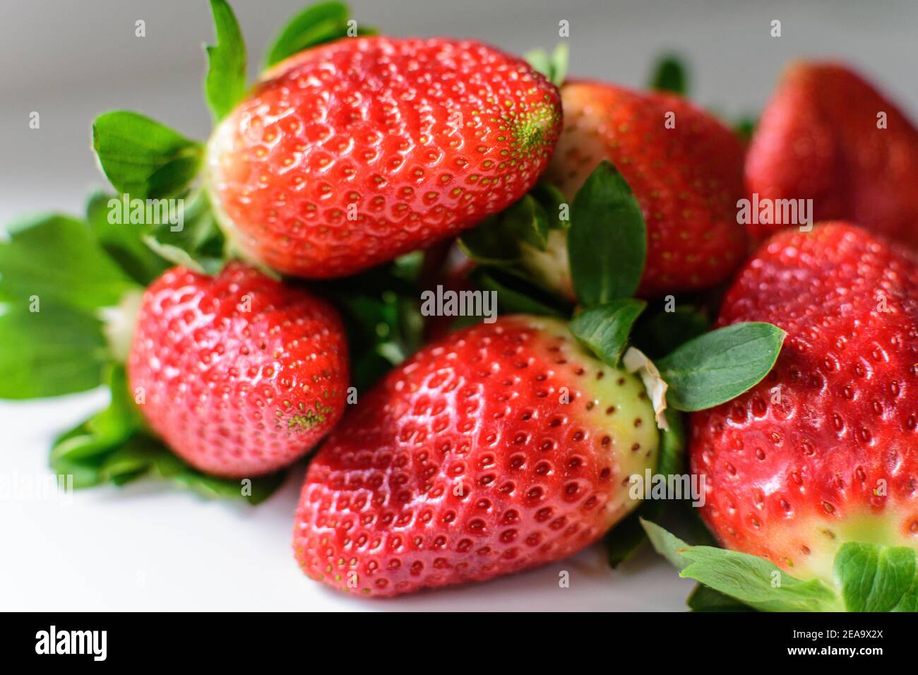 A bunch of bright red strawberries on a white background Stock Photo ...