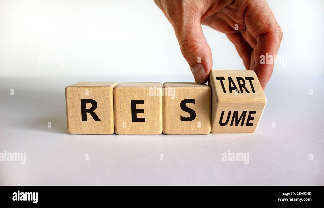 Resume and restart symbol. Businessman hand turns cubes and changes the ...