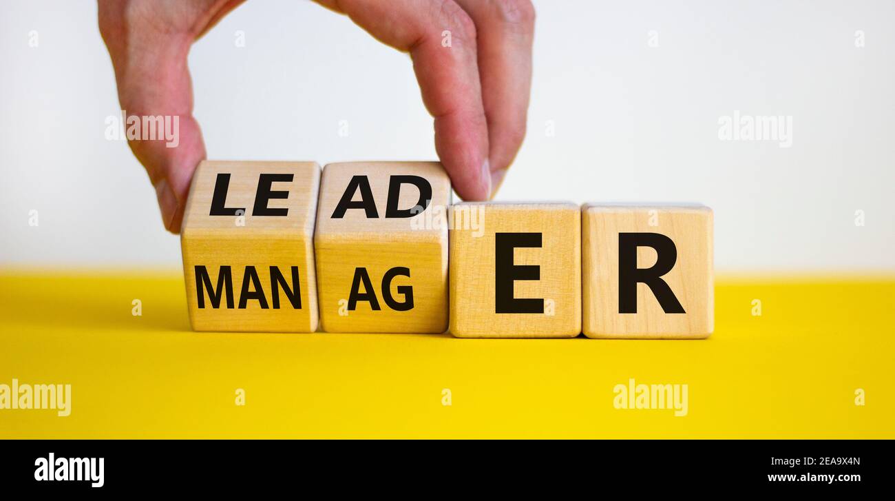 Manager versus leader symbol. Businessman flips wooden cubes and ...