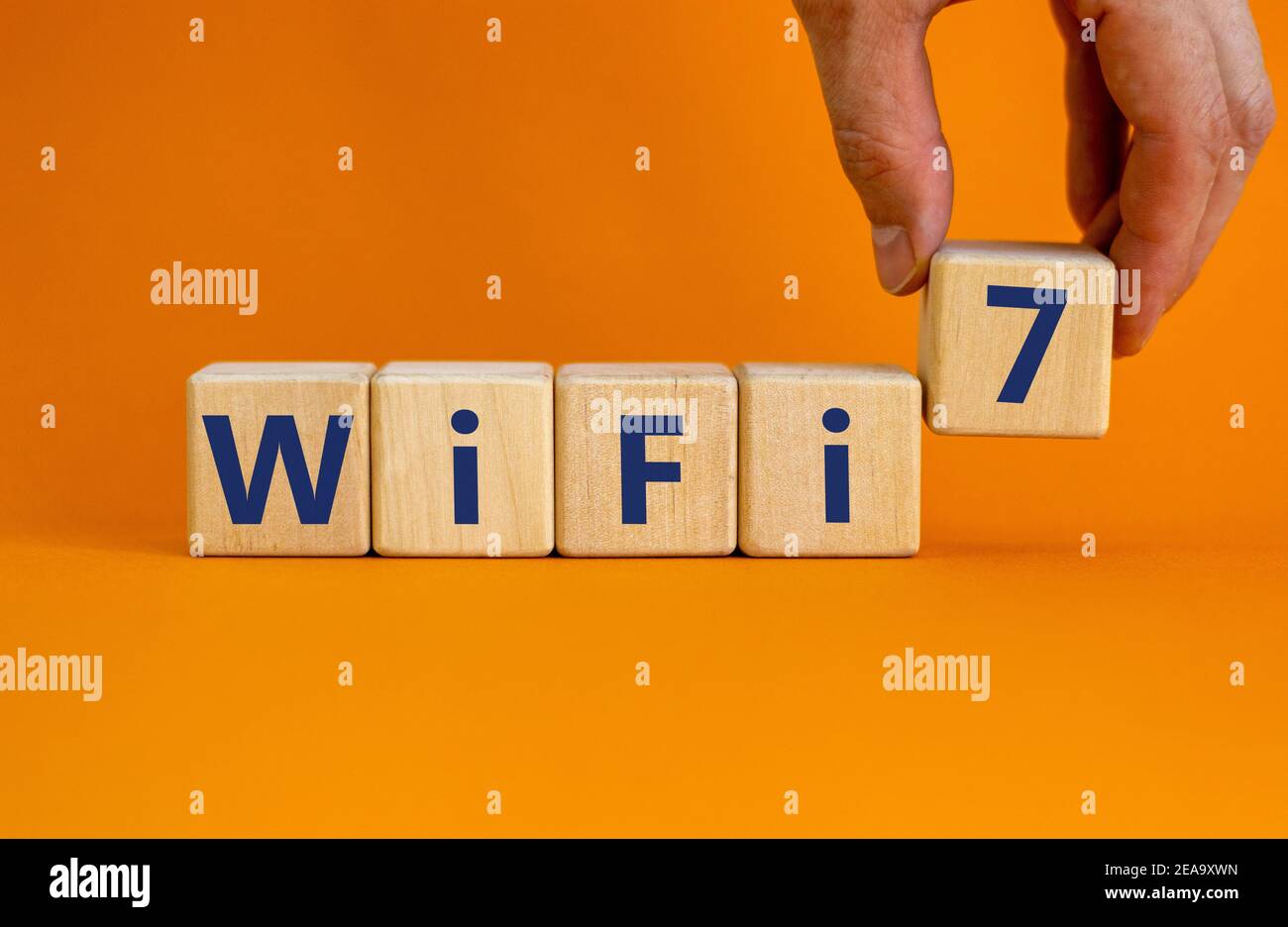 WiFi 7 symbol. Businessman holds a wooden cube with words WiFi 7 ...