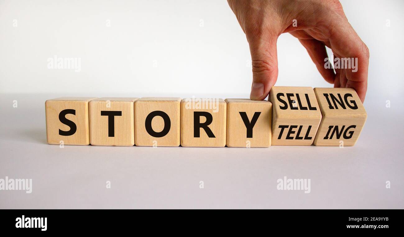 Storytelling or storyselling symbol. Businessman turns wooden cubes and ...