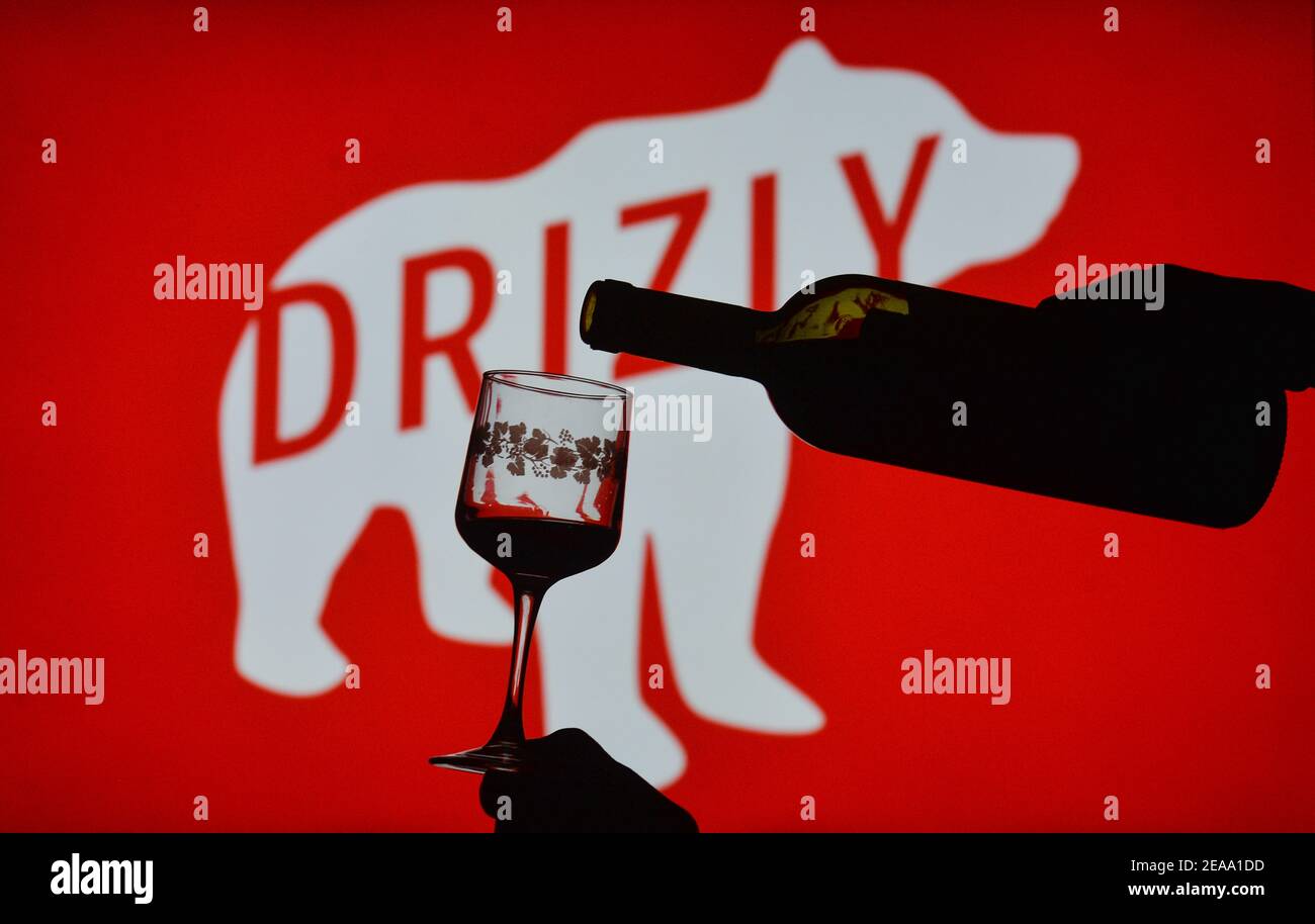 In this photo illustration a silhouette of a hand pouring wine into a ...