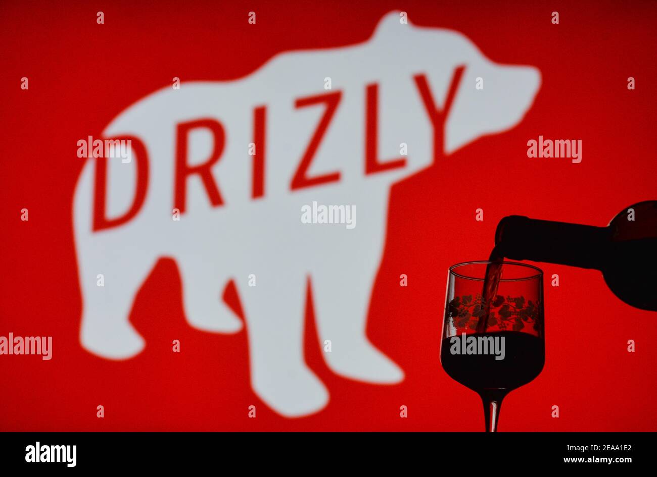 In this photo illustration a silhouette of a hand pouring wine into a ...