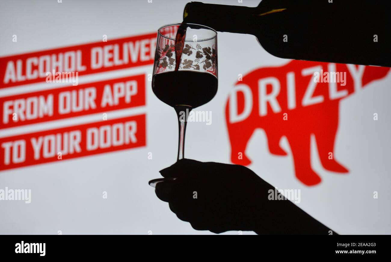 In this photo illustration a silhouette of a hand pouring wine into a ...