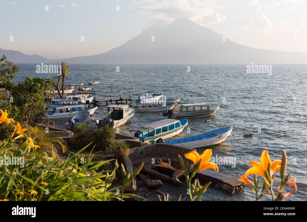 Panajachel, Lake Atitlan Guatemala Boats sit on Lake Atitlan framed by ...