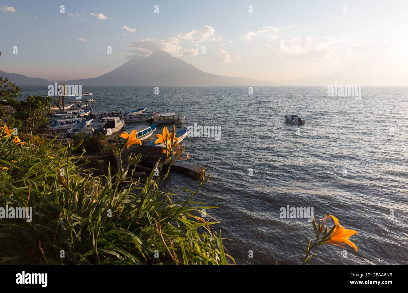 Panajachel, Lake Atitlan Guatemala Boats sit on Lake Atitlan framed by ...