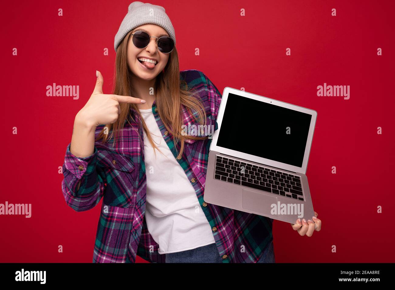 Shot of laughing funny smiling young woman holding computer laptop ...