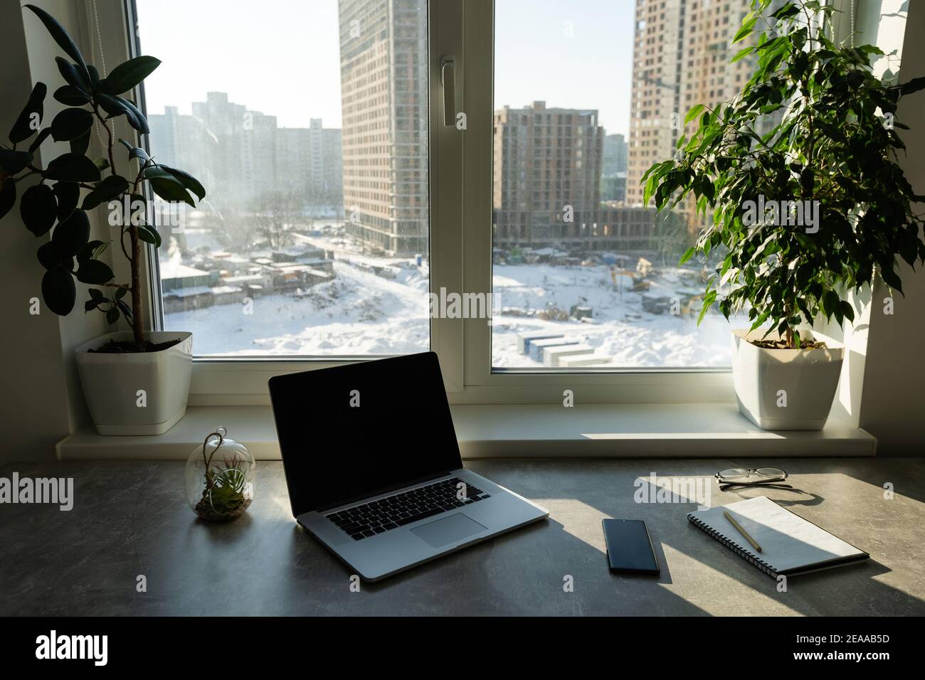 Still life view of office room with open laptop computer on desk with ...