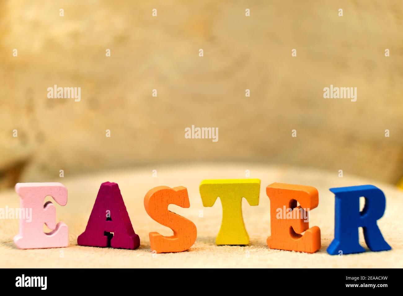 Word Easter of colorful toy alphabet letters on on wooden table ...