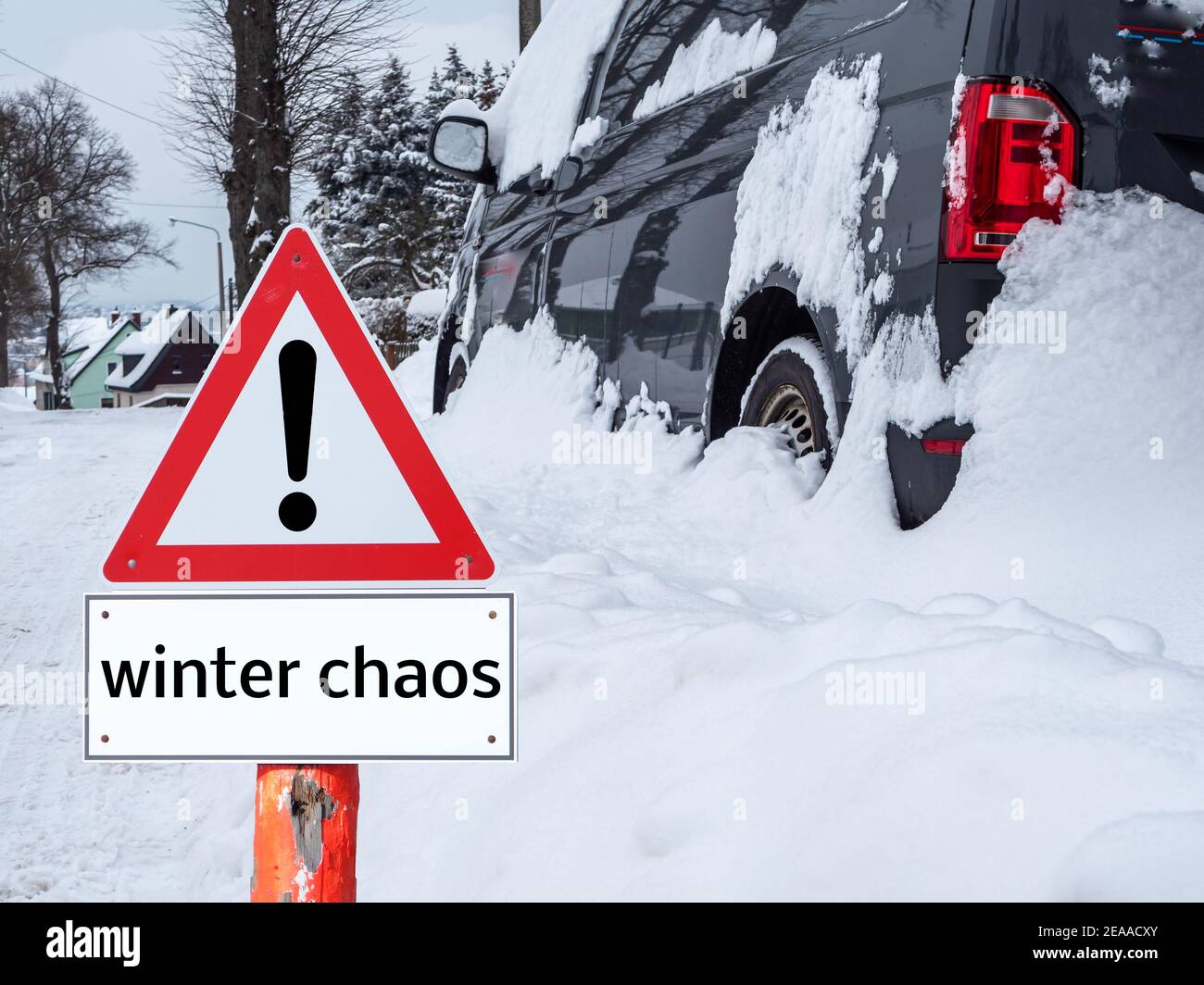 Warning sign "winter chaos" Car stuck in the snow Stock Photo - Alamy