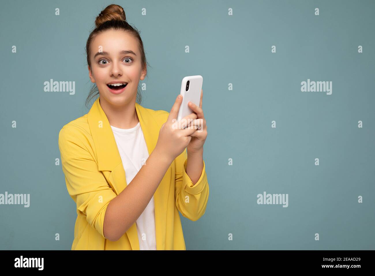 Photo shot of attractive positive good looking young lady wearing ...